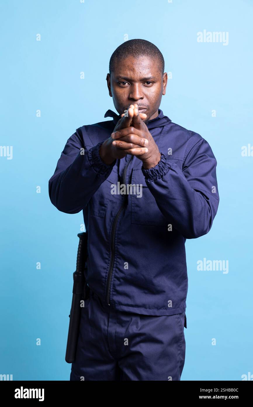 African american security guard mimics target practice shooting with an ...