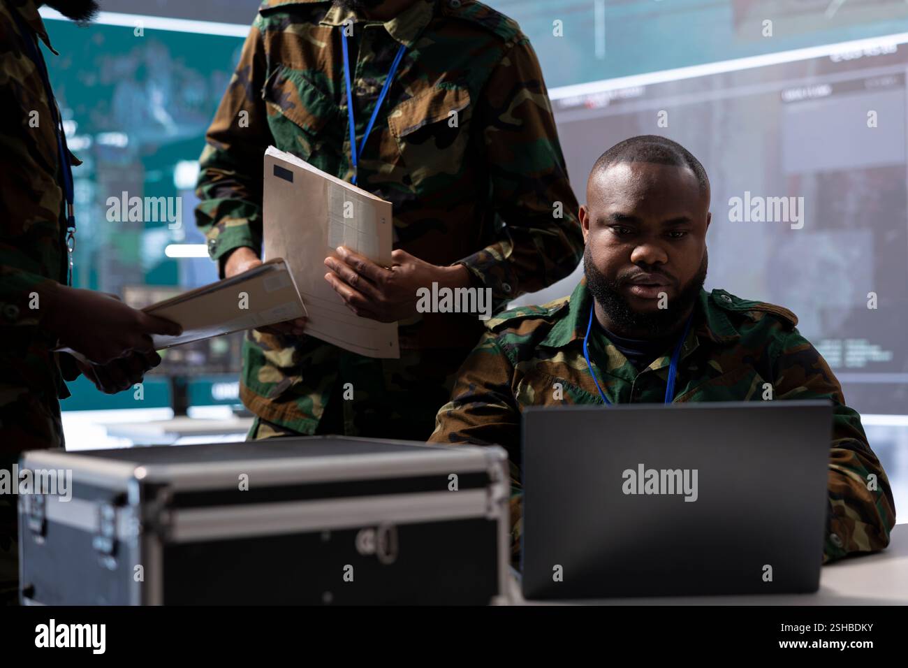 Military analysts in a modern control center power base overseeing ...
