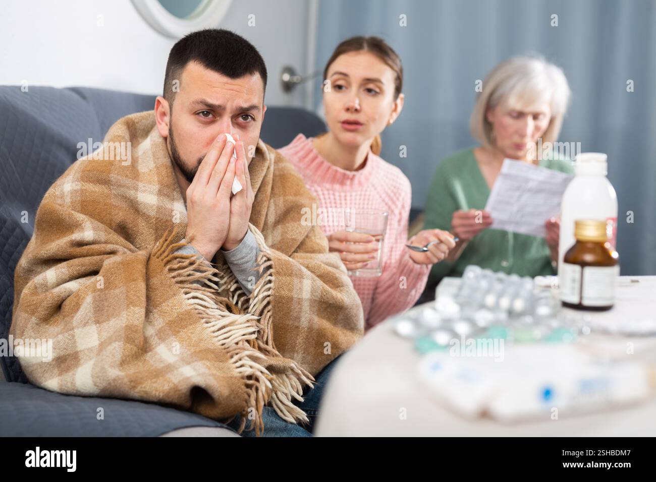 Elderly Mother And Young Wife Take Care Of Her Husband During Illness