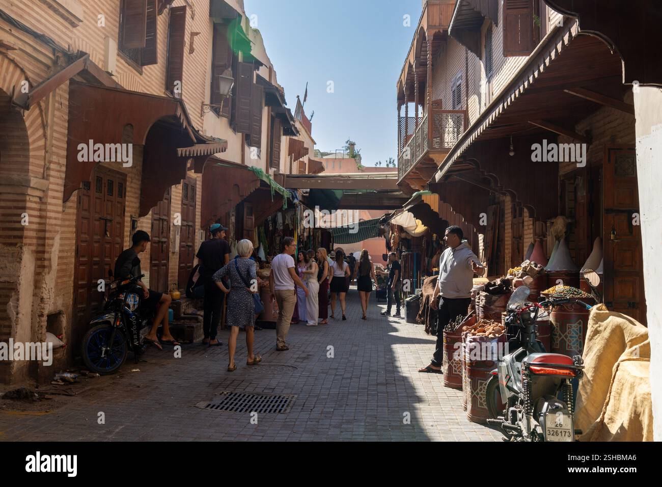 Souk of Marrakech Medina street life, tourists and locals walking ...