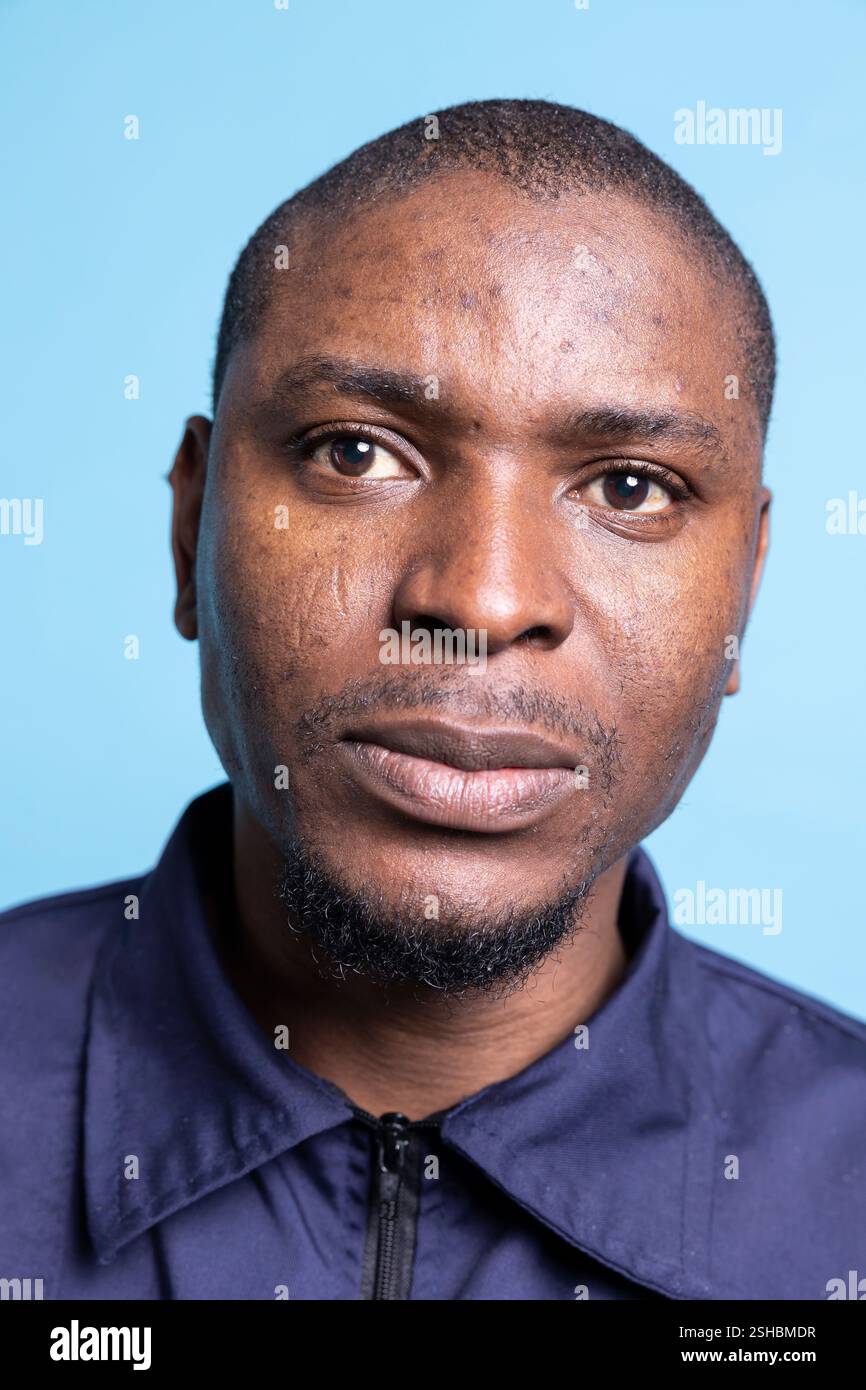 Portrait of serious security officer in professional uniform on camera ...