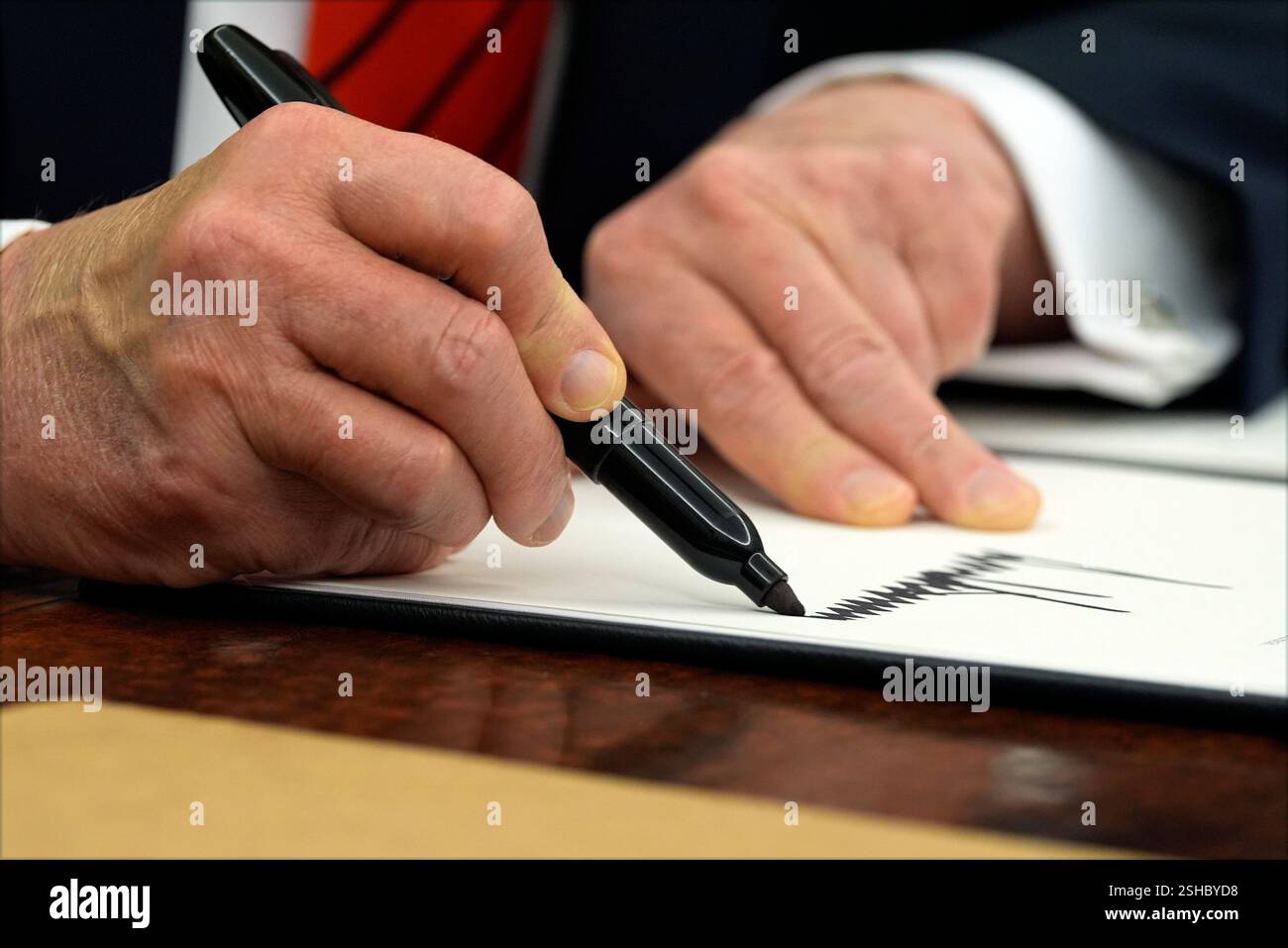President Donald Trump signs an executive order in the Oval Office at ...