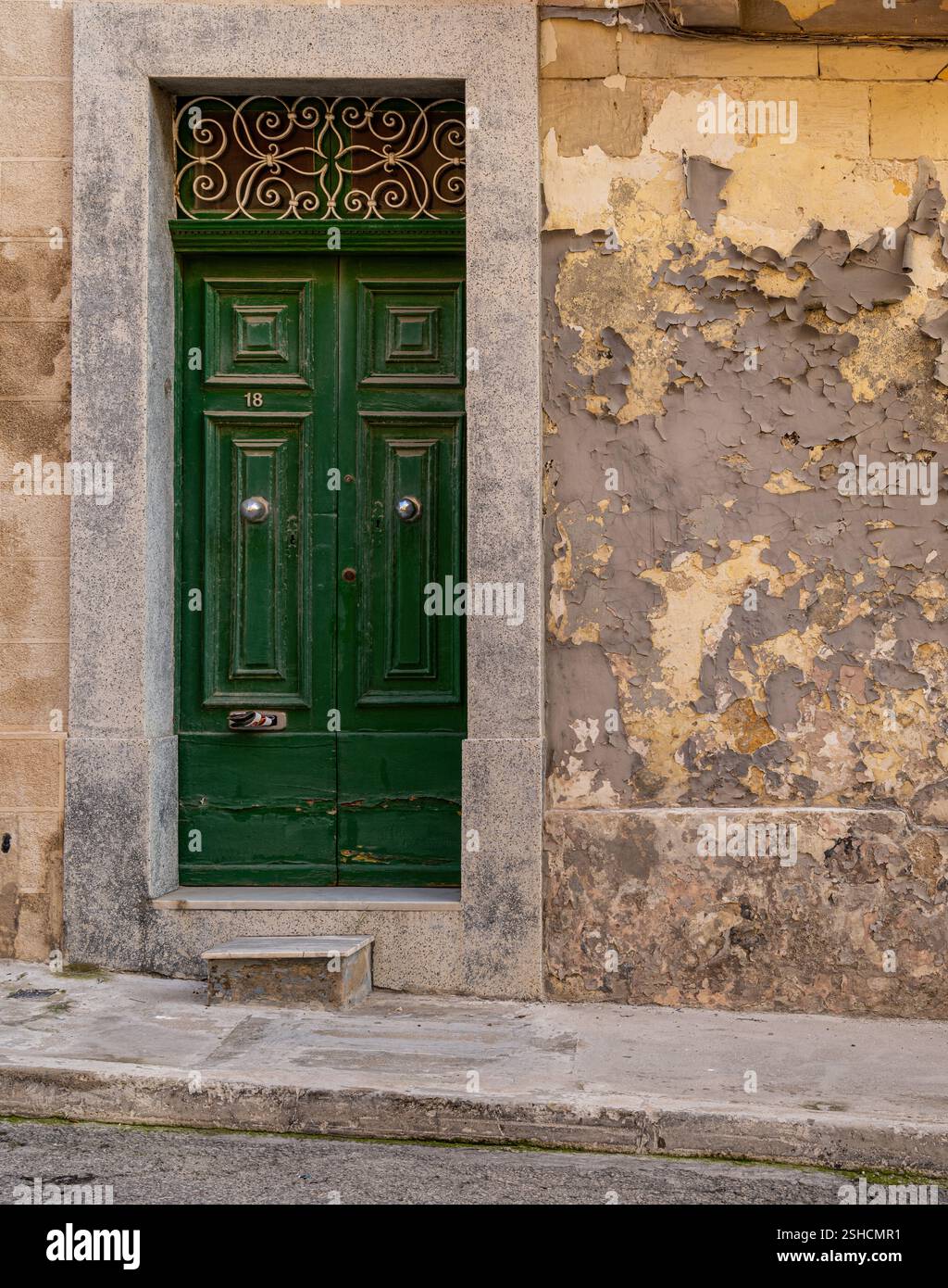 Traditional house detail in Malta. Limestone yellow bricks and colorful ...