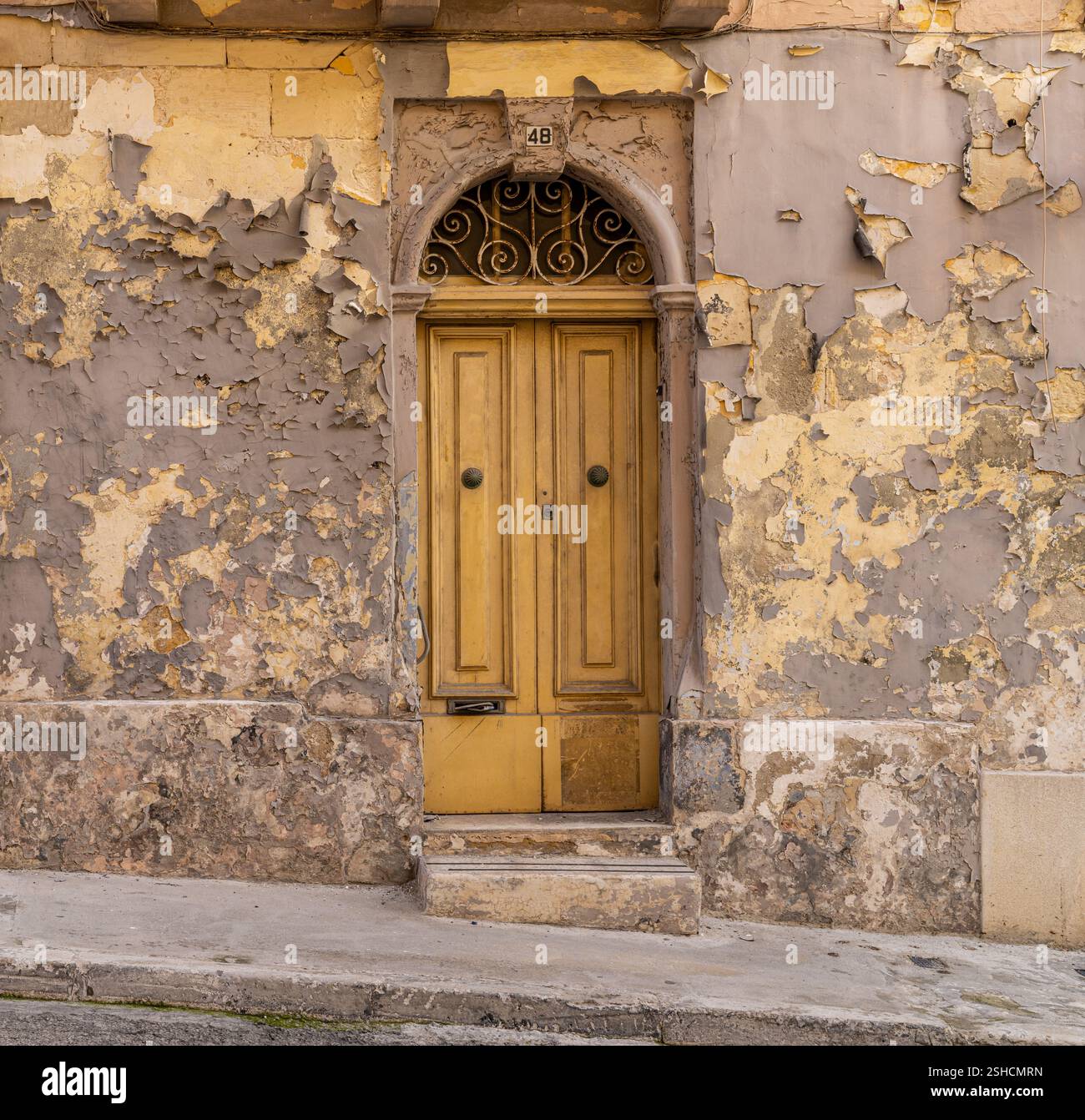 Traditional house detail in Malta. Limestone yellow bricks and colorful ...