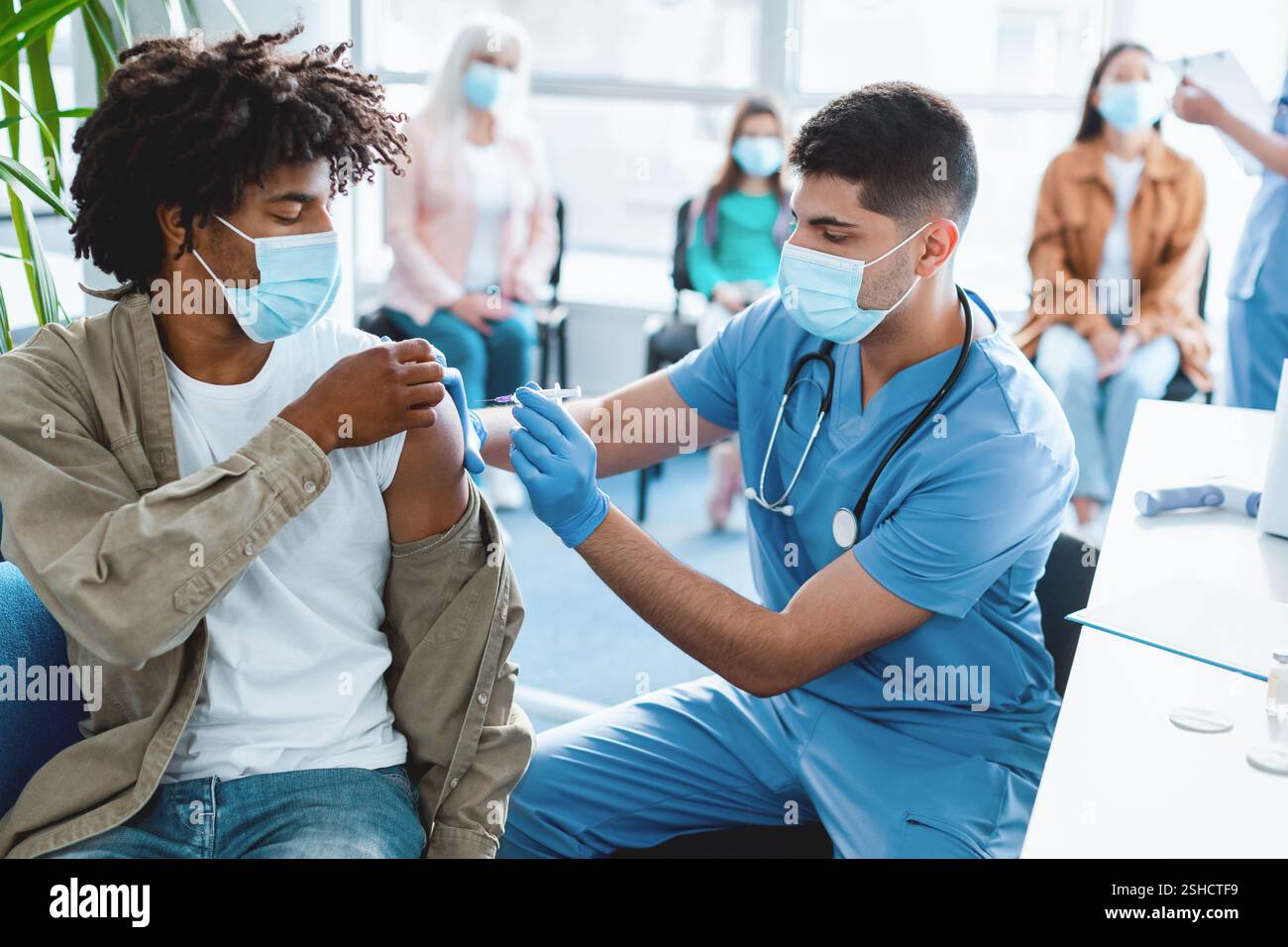 African American Guy Receiving Vaccine Injection In Arm In Health ...