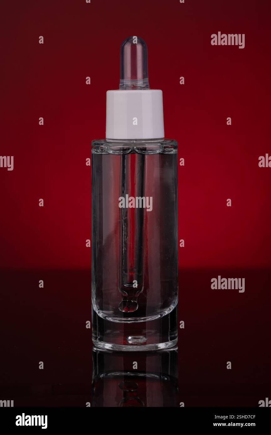 Transparent Glass Dropper Bottle with Liquid on Red Background Stock ...
