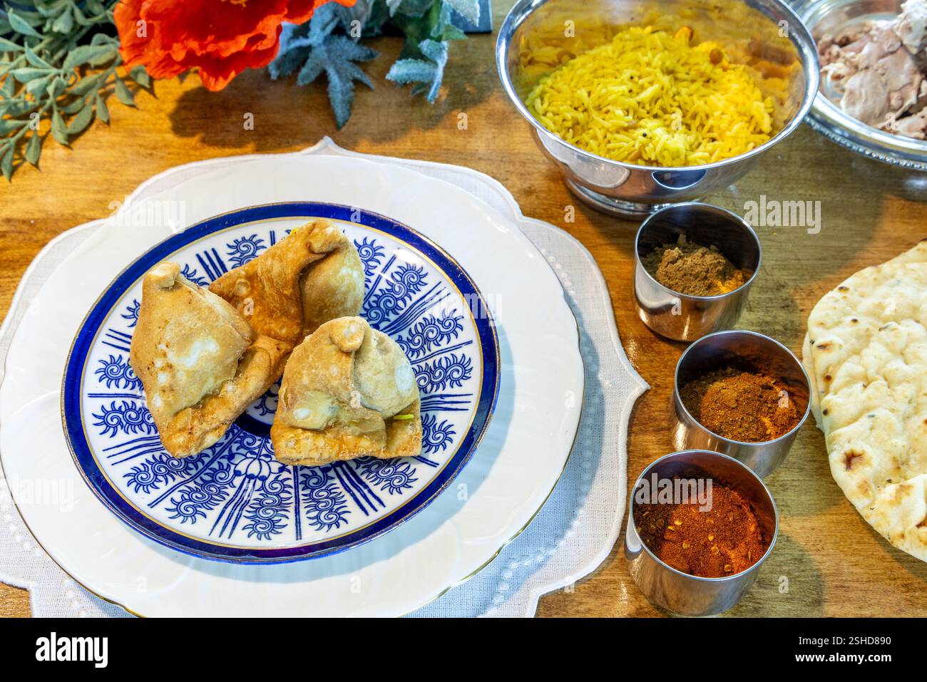 Samosas with various spices, saffron rice, naan bread and duck meat at ...