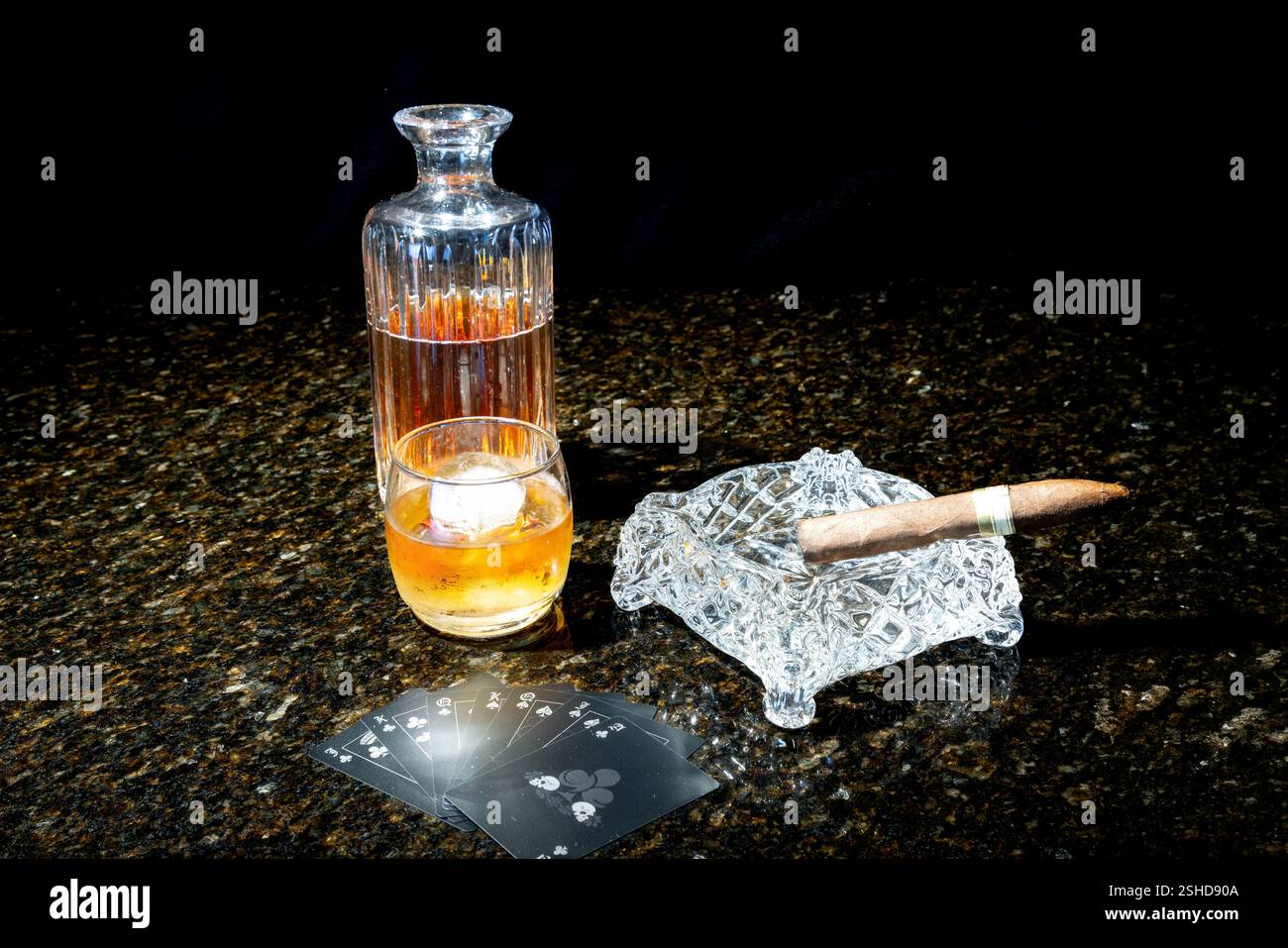 Crystal glass of whisky with an ice cube shaped like a skull and a ...