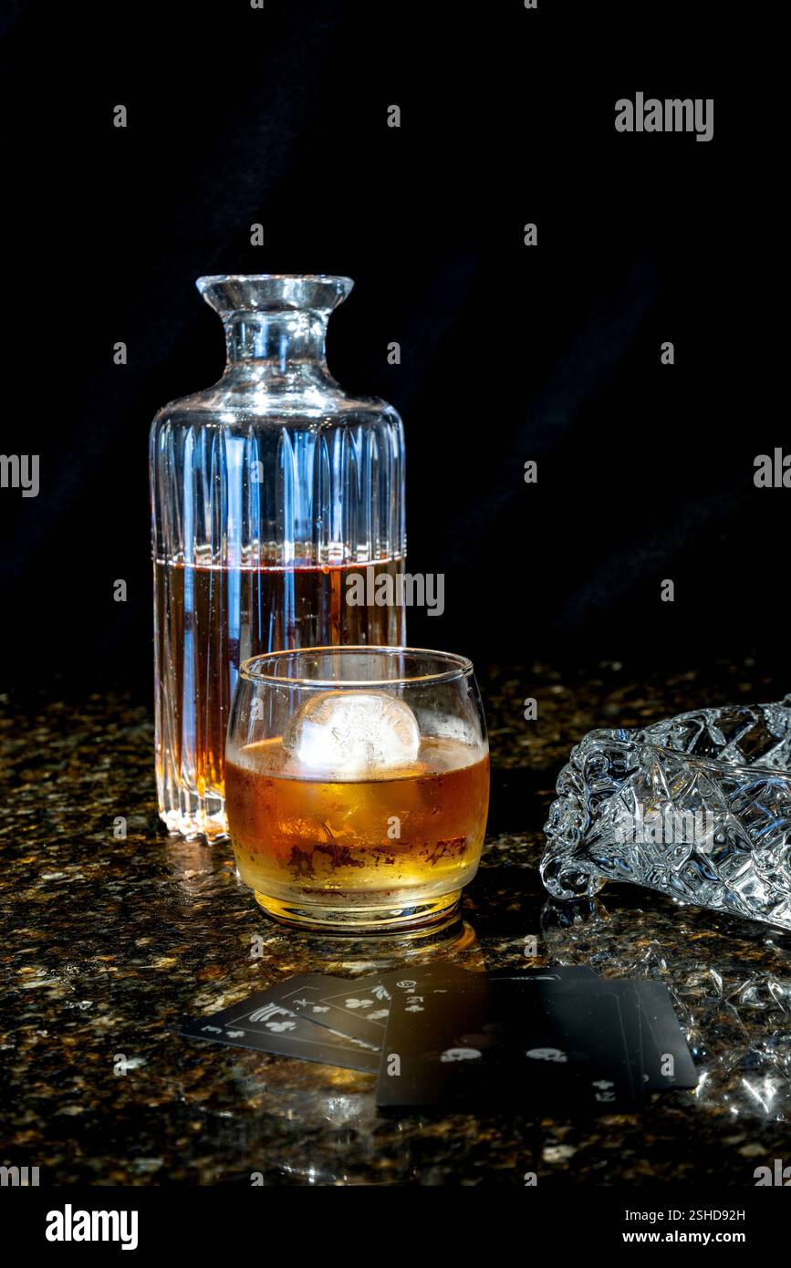 Crystal glass of whisky with an ice cube shaped like a skull and a ...