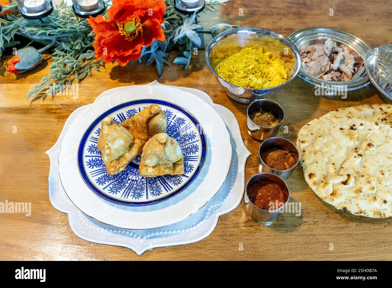 Samosas with various spices, saffron rice, naan bread and duck meat at ...