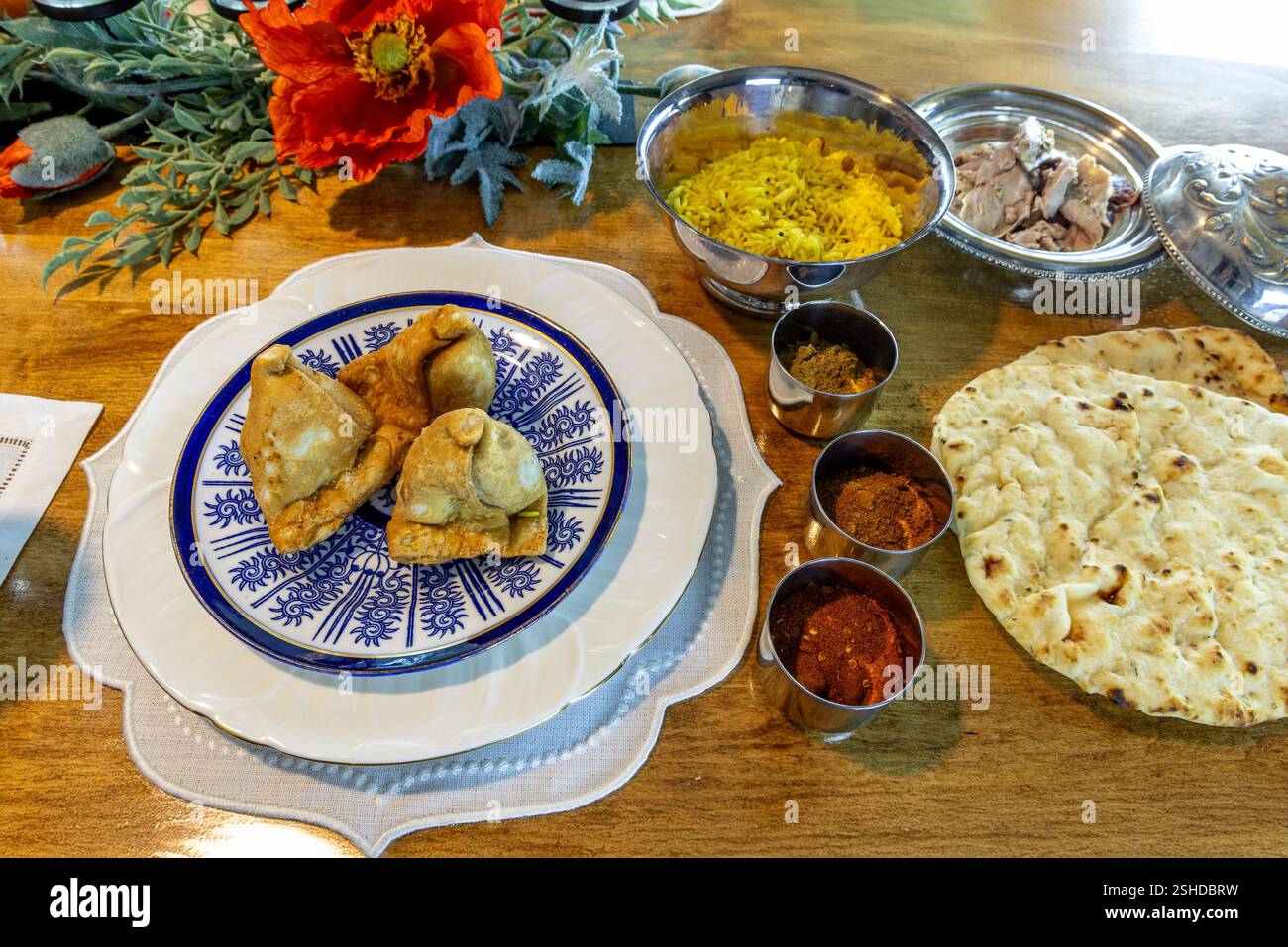 Samosas with various spices, saffron rice, naan bread and duck meat at ...