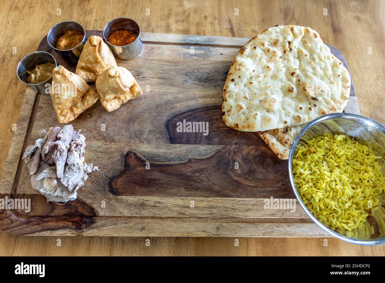 Indian food, including samosas with various spices, saffron rice, naan ...