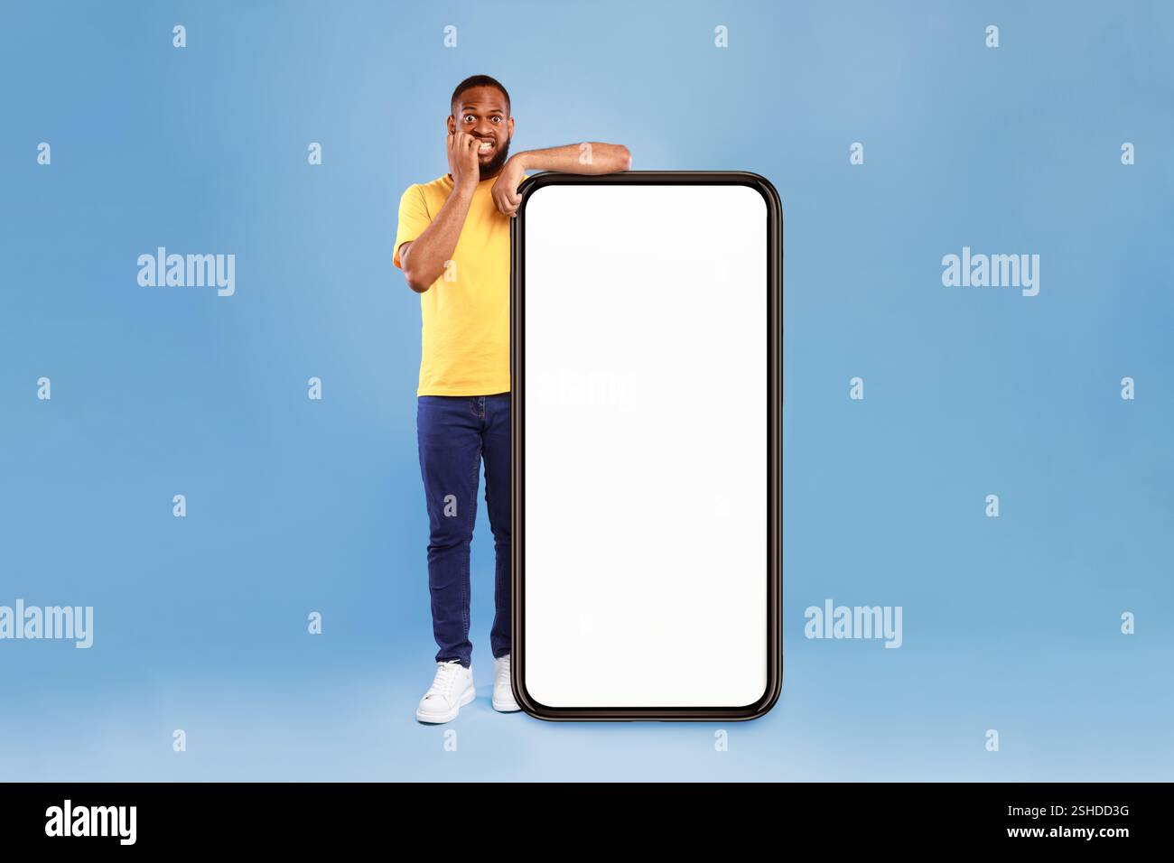 African American guy leaning on giant smartphone with blank screen ...