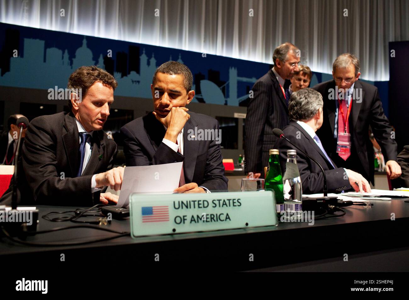 President Barack Obama confers with U.S. Treasury Secretary Timothy ...