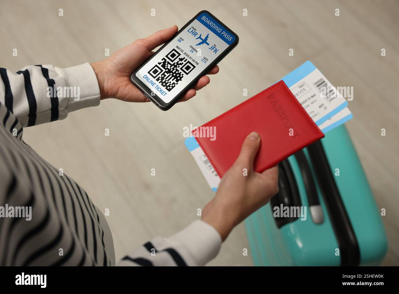 Tourist with passport, flight tickets and mobile phone indoors, above ...