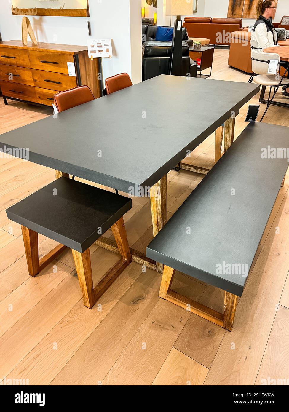Modern dining table set with bench seating Stock Photo - Alamy
