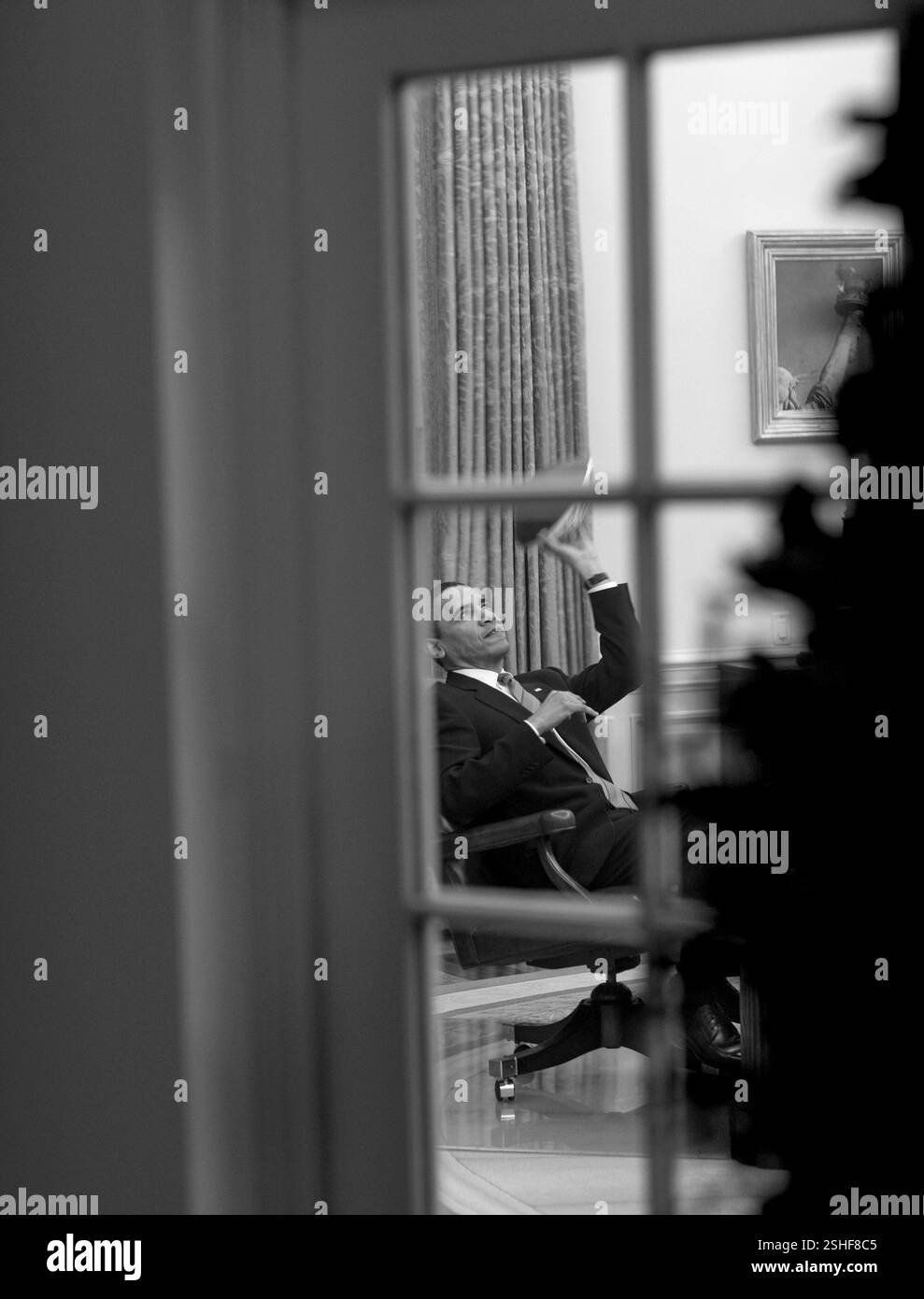 President Barack Obama plays with a football in the Oval Office 4/23/09 ...