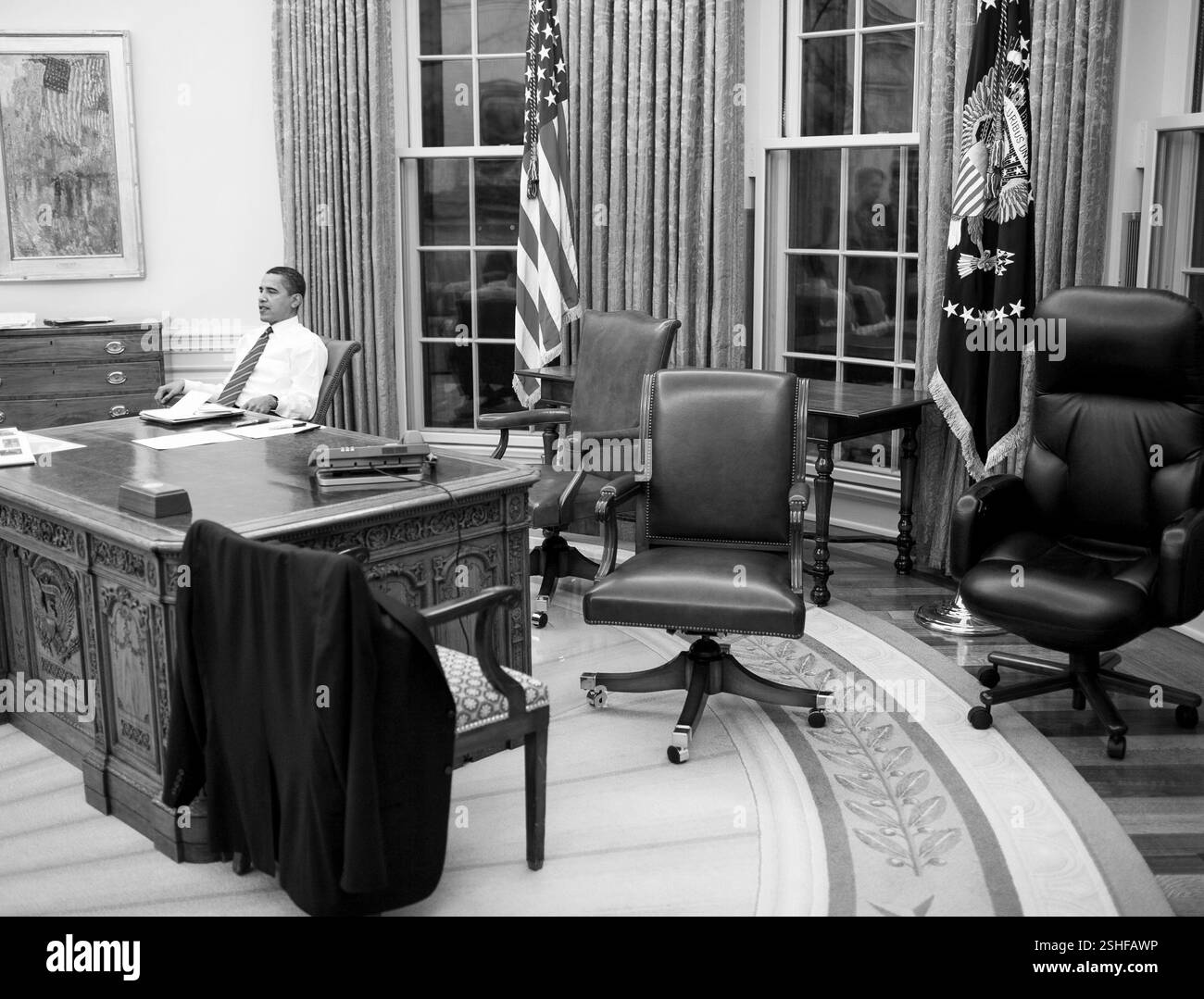 President Barack Obama tries out different desk chairs in the Oval ...