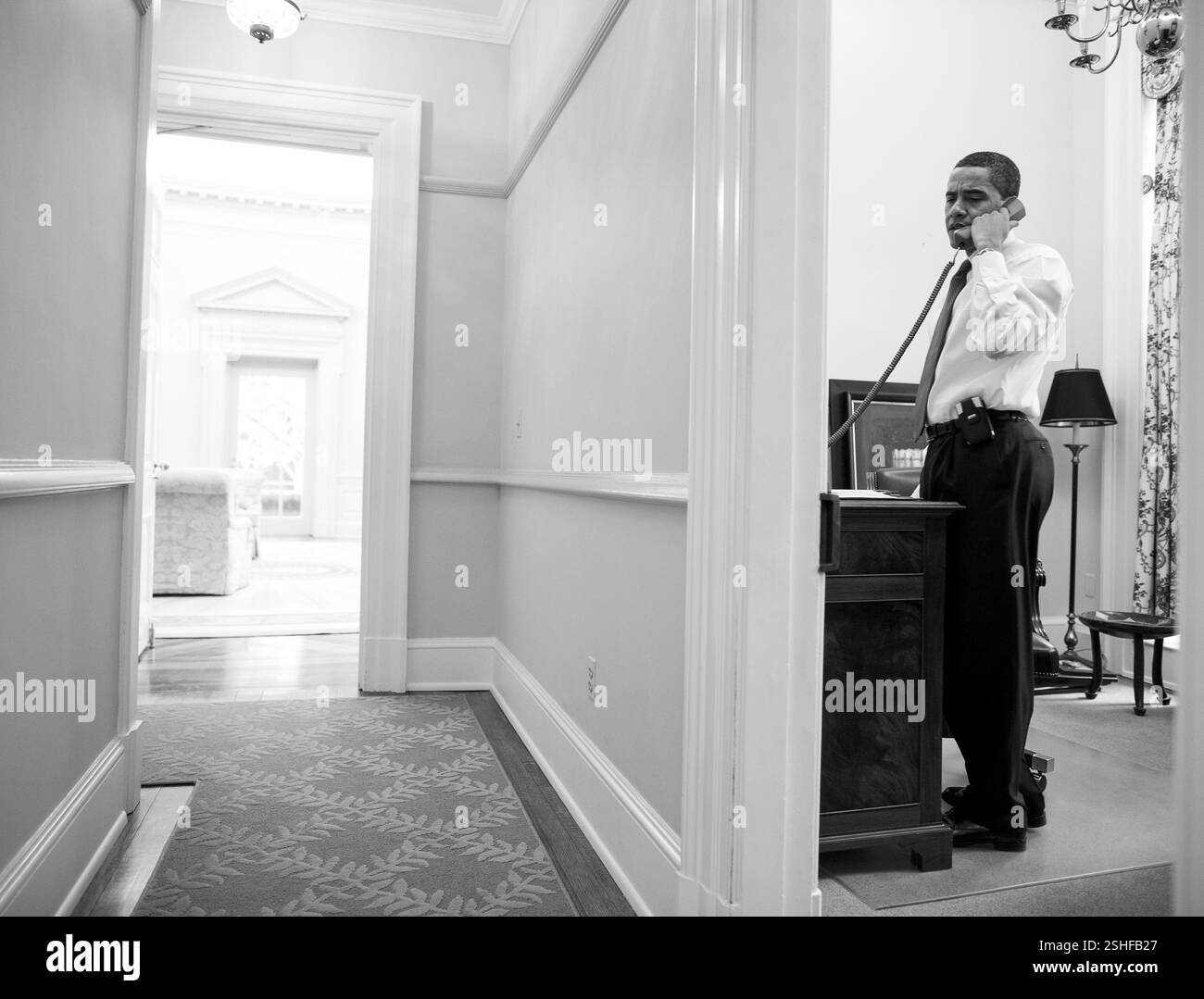 President Barack Obama takes a phone call in his private study off the ...