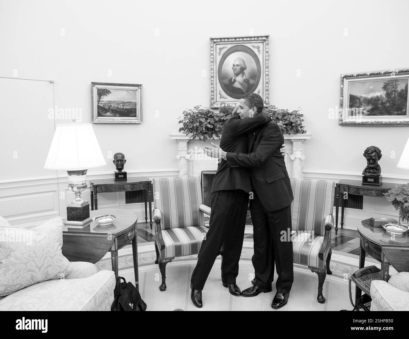President Barack Obama hugs Interior Secretary Ken Salazar in the Oval ...