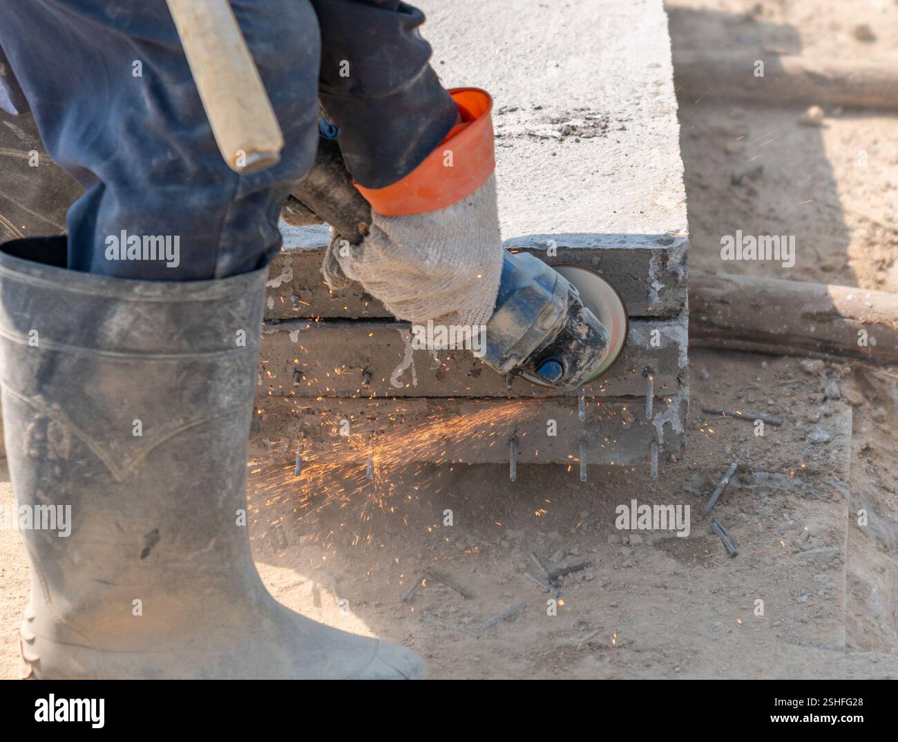 Close up worker is using grinder for cutting reinforcing steel on ...