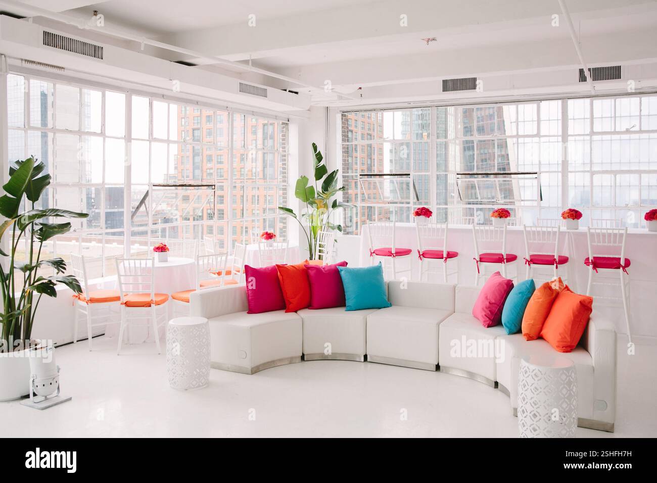 Cozy lounge area featuring colorful cushions, plants, and seating ...