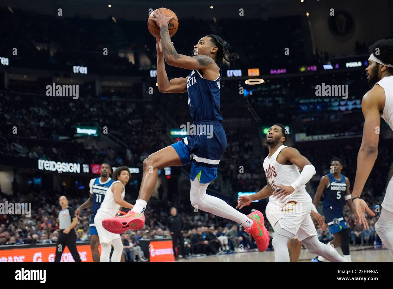 Minnesota Timberwolves guard Rob Dillingham, left, goes to the basket ...