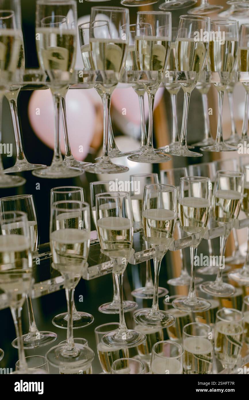 Rows of sparkling champagne glasses arranged for a joyful celebration ...