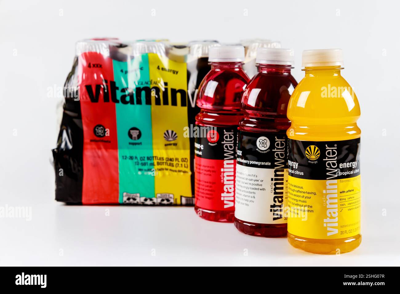 Variety of flavored vitamin water bottles displayed with pack on simple ...