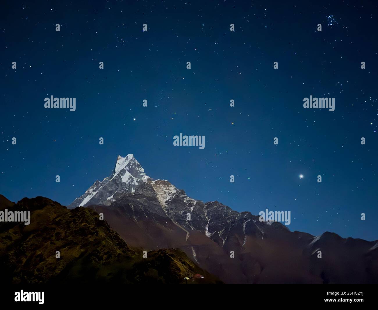 The sacred mountain Machapuchare, also known as the Fish Tail, rises to ...