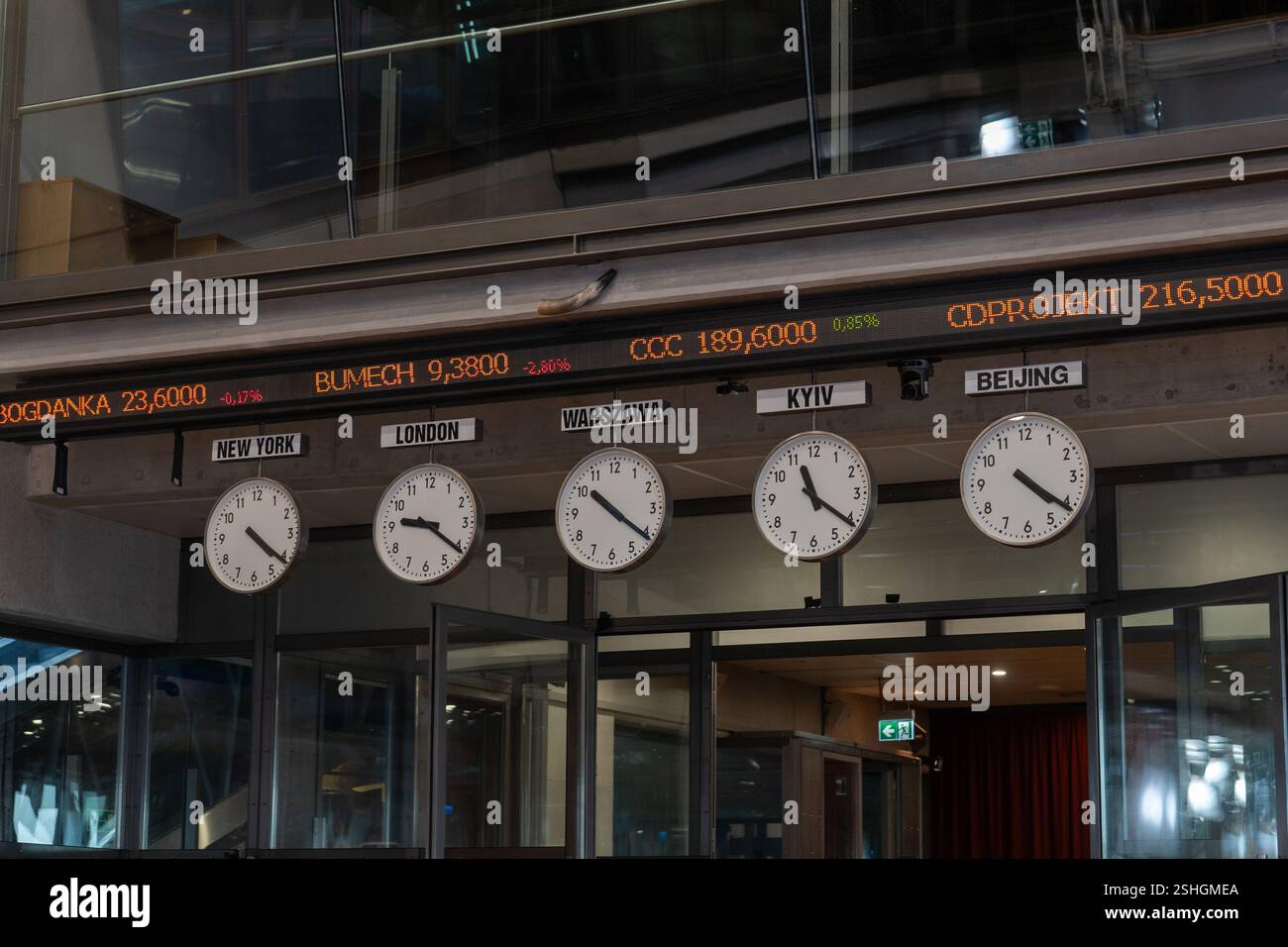 Stock exchange rates and world clocks are pictured before the event ...
