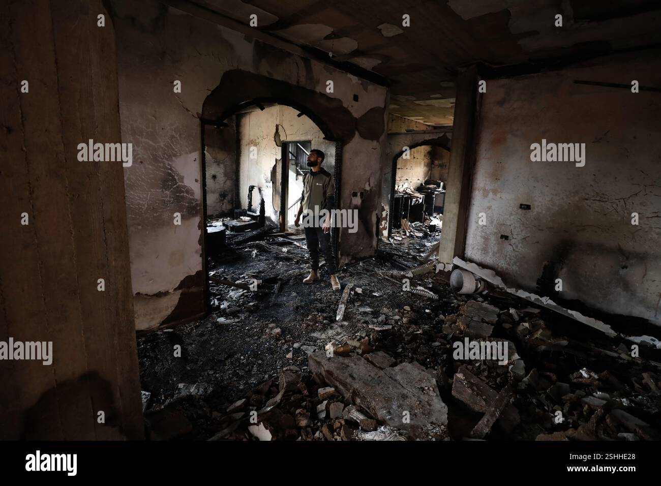 Jenin. 10th Feb, 2025. A Palestinian inspects a destroyed house after ...