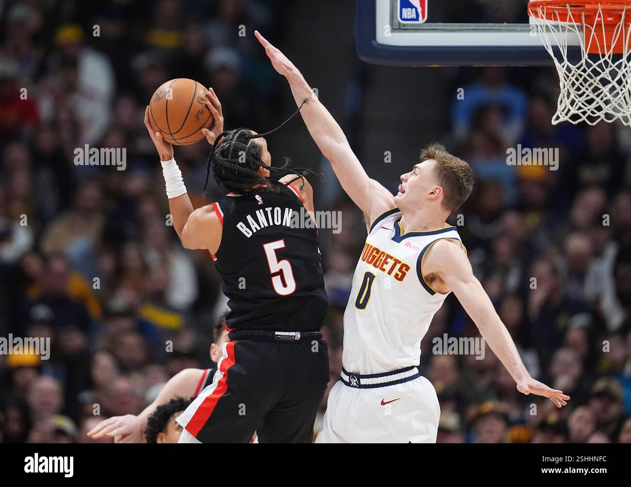 Portland Trail Blazers guard Dalano Banton, left, goes up for a basket ...