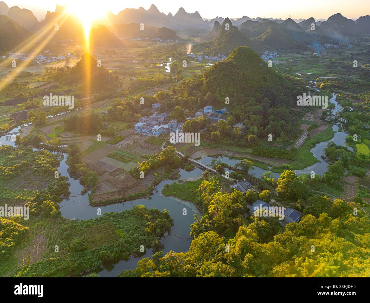 Iconic shot of the river going through the village and karst mountains in Wuzhishan Scenic Area ...
