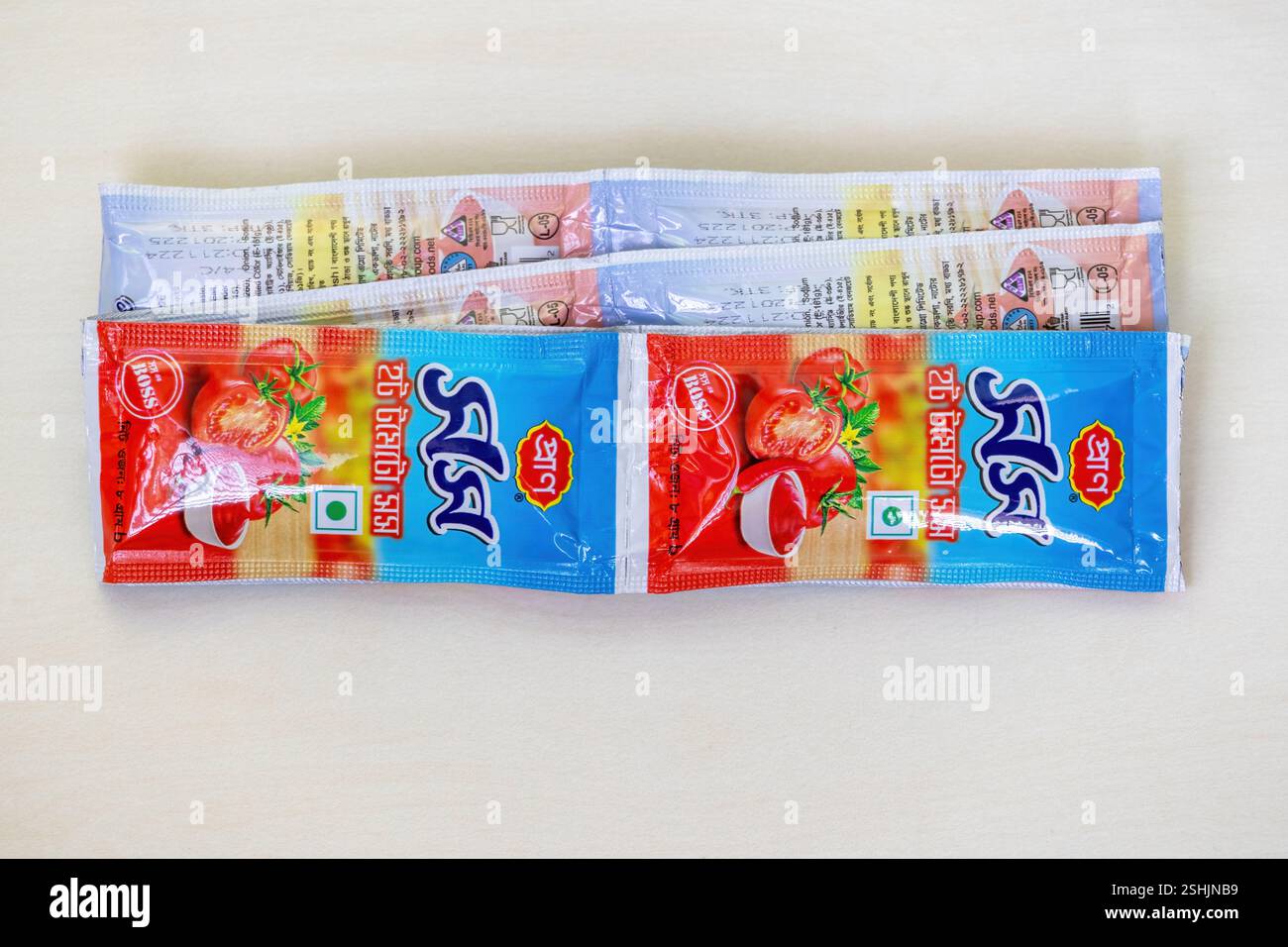 Mini packets of PRAN Hot Tomato Sauce, top view. A fiery blend of ...