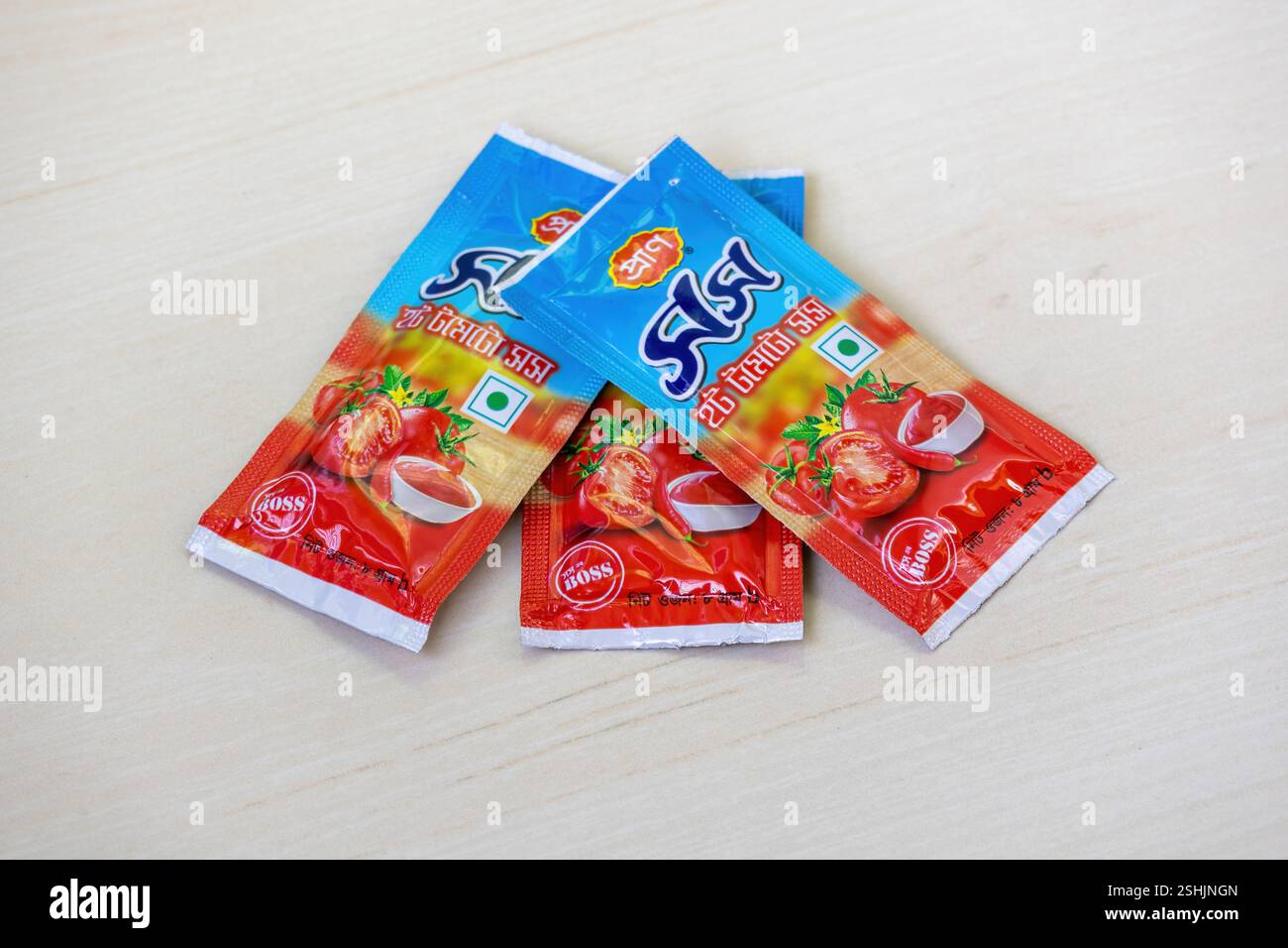 PRAN Hot Tomato Sauce Mini Packets, showcased on a light wooden ...