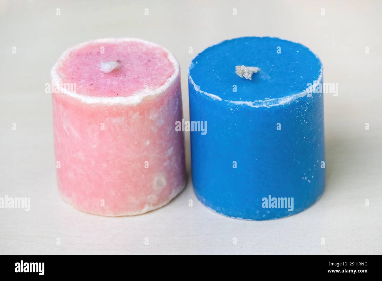 Two beautiful new candles in pink and blue colors, fireless, are shown ...