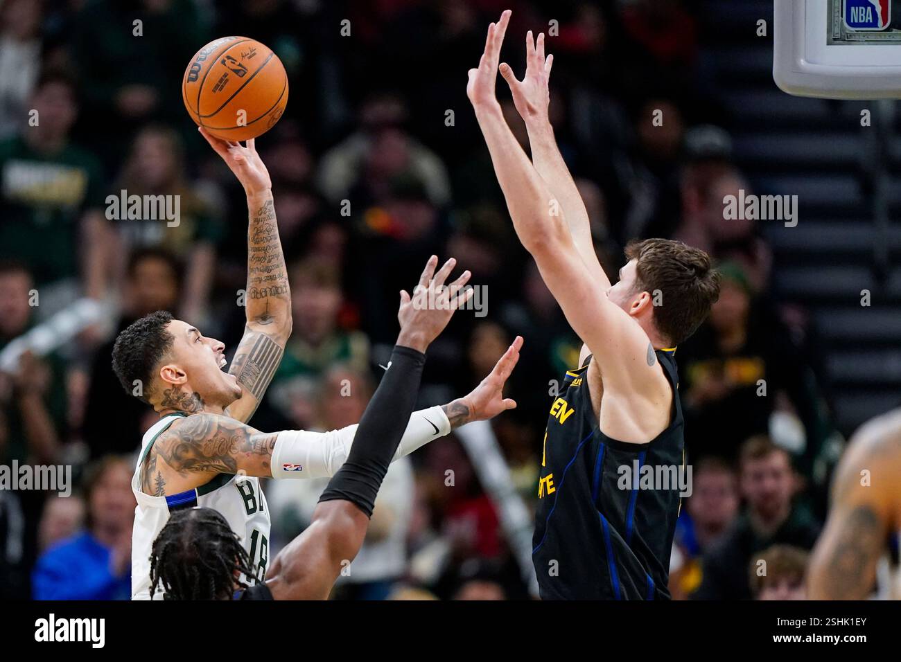 Milwaukee Bucks' Kyle Kuzma, top left, looks to shoot against Golden ...