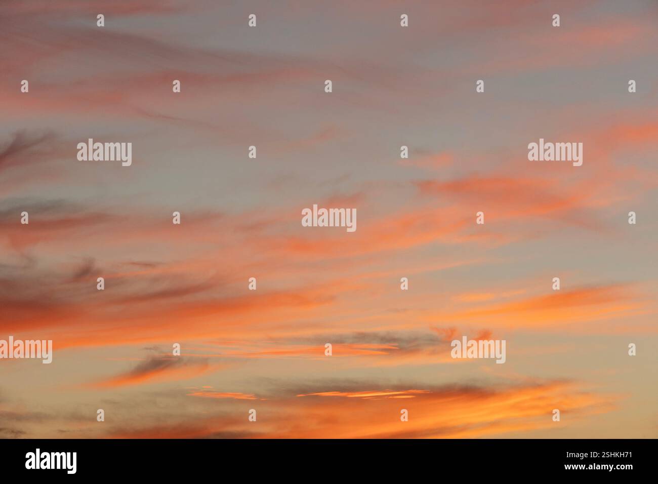A breathtaking view of a vibrant sunset sky, with soft orange and pink ...