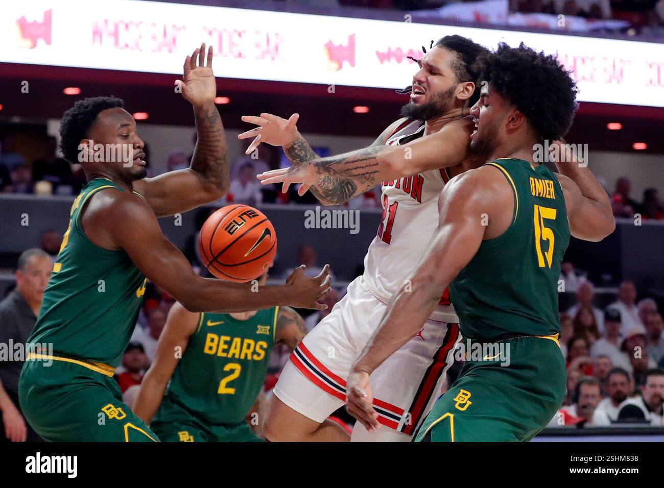 Houston guard Emanuel Sharp, center, has his shot-attempt knocked away ...
