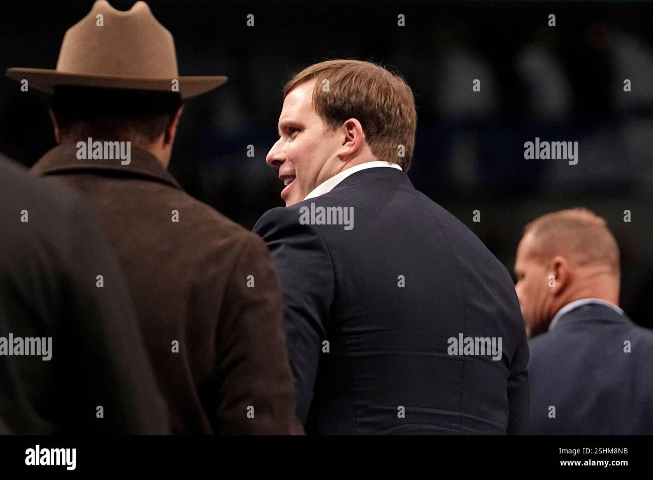 Dallas Mavericks Governor Patrick Dumont, center, walks to his seat in ...