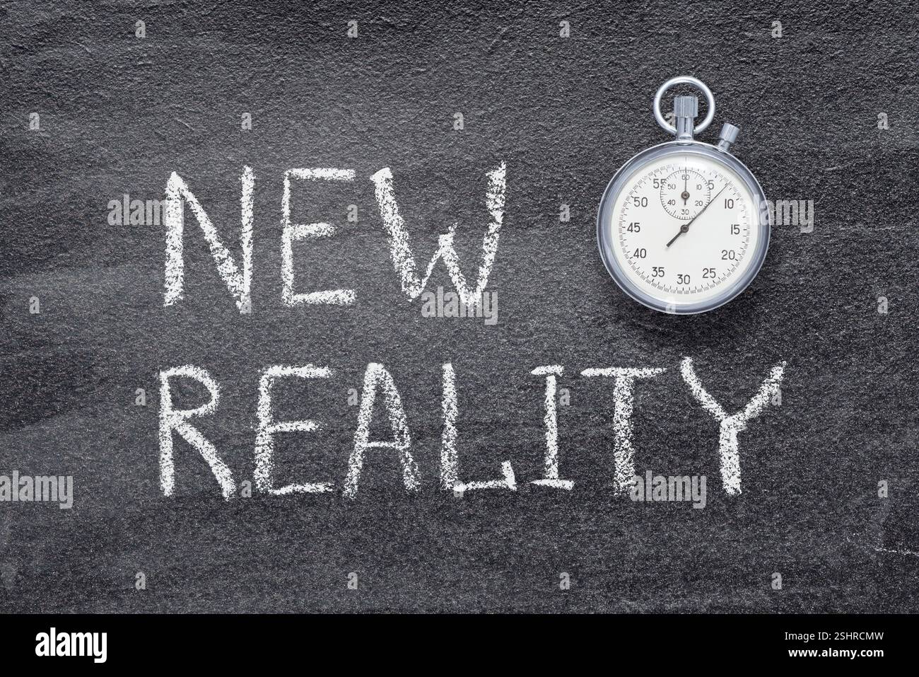 new reality phrase written on chalkboard with vintage precise stopwatch ...