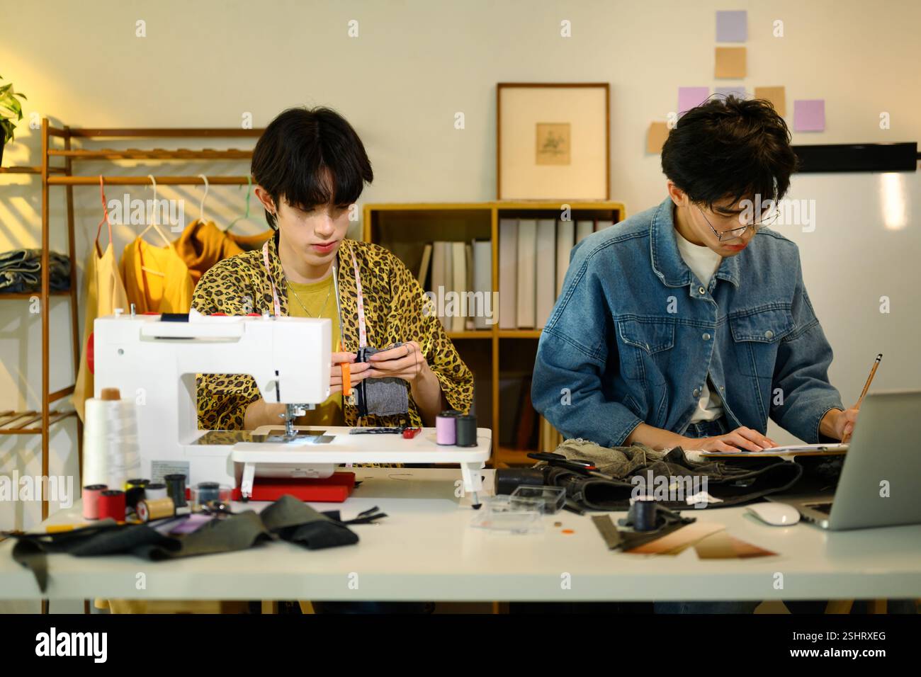 Creative fashion designers working on new designs in a stylish ...