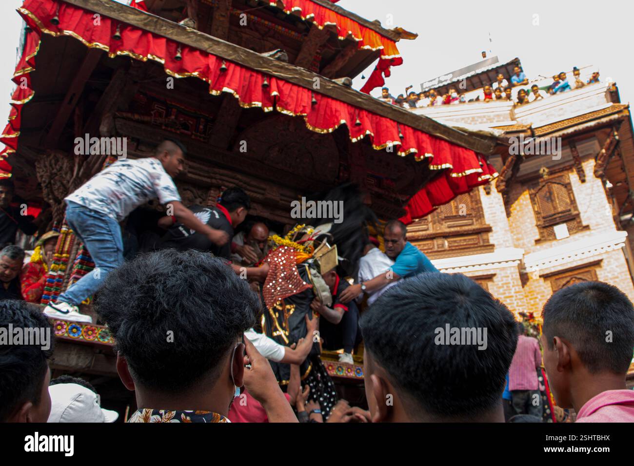 Biska Jatra devotees mount Bhairav idol on the three-tiered gigantic yellow chariot. He is then ...