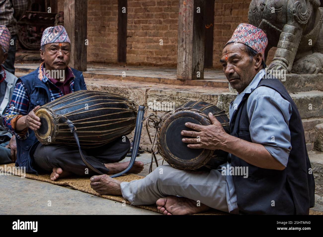 Devotees plays Lala Khee:, a double-headed drum at a Bhajan Mandali of ...