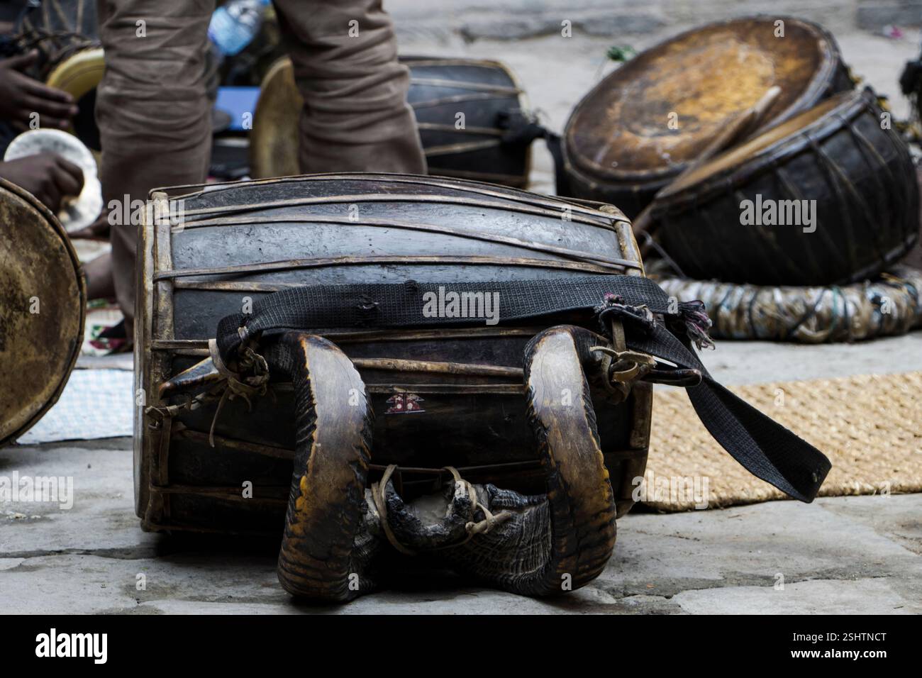 A Double Headed Drum with sheep horns attached to it. The Dhaa: is one ...