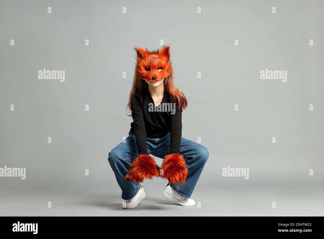 Quadrobics. Girl wearing fox mask and gloves on grey background Stock ...