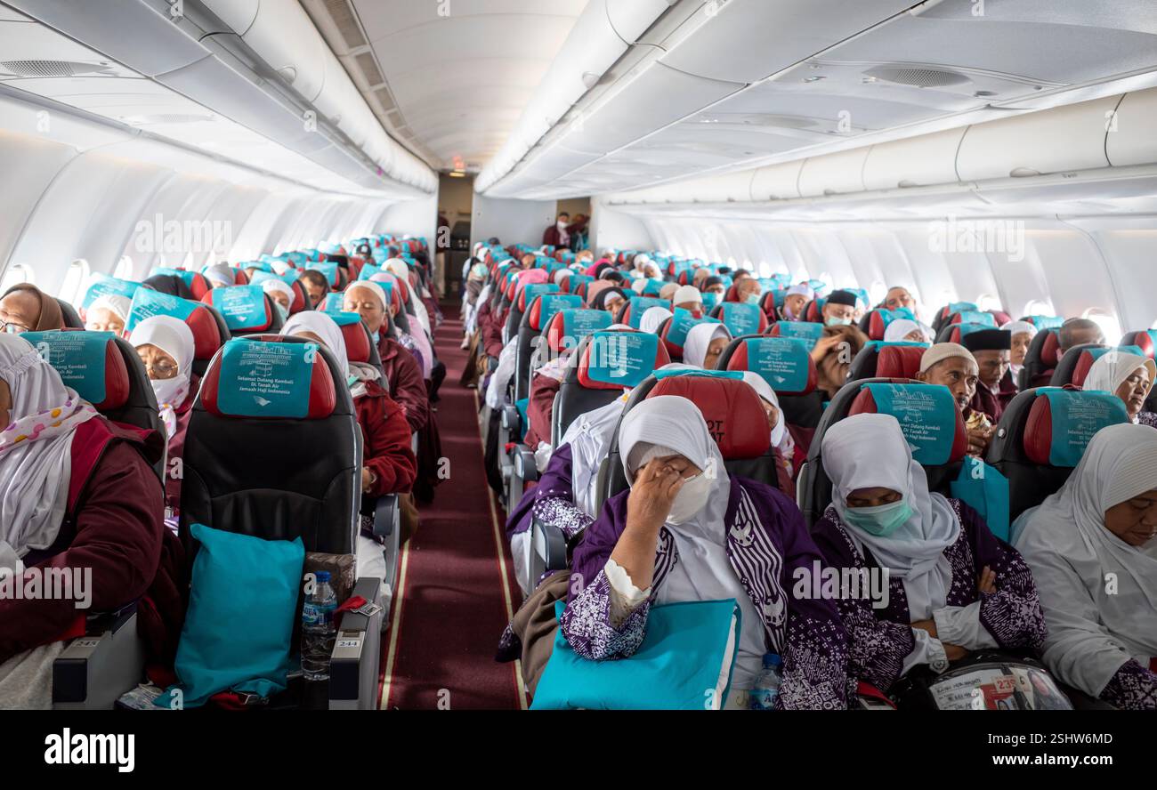 Medina, Saudi Arabia - July 6, 2024: Indonesian Hajj pilgrims on the plane, returning home after ...