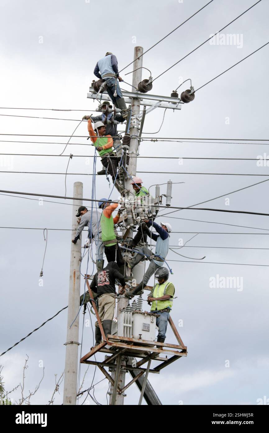 Electrical workers performing maintenance and installation on power ...