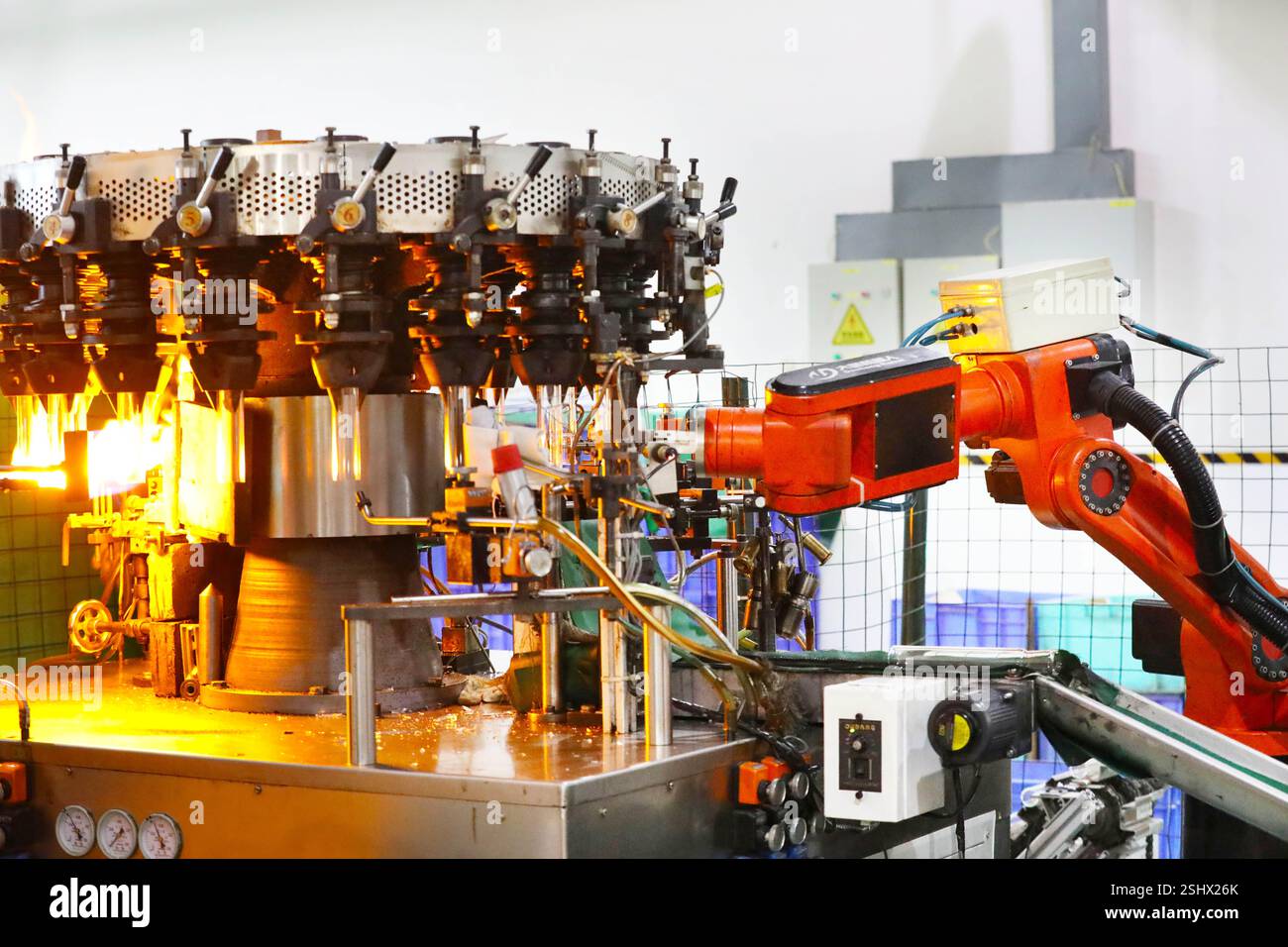 A robot produces glass instruments at a workshop in Chongqing, China ...